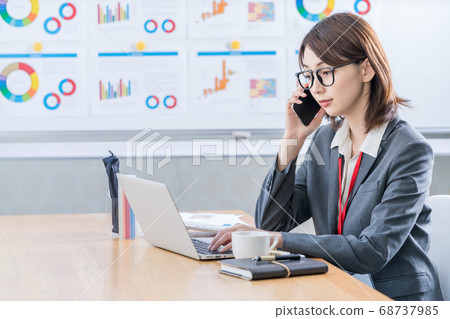 Business woman typing on a computer while calling - Stock Photo ...