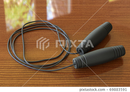 Skipping rope or jump rope on the wooden table,... - Stock Illustration ...