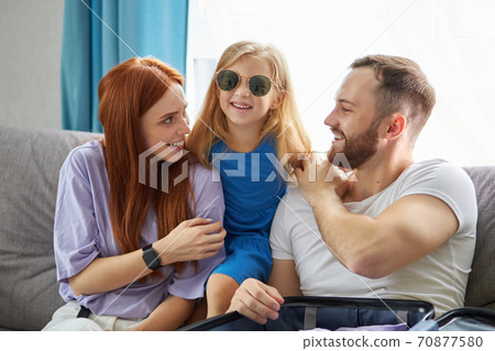 beautiful caucasian family with child packing... - Stock Photo ...