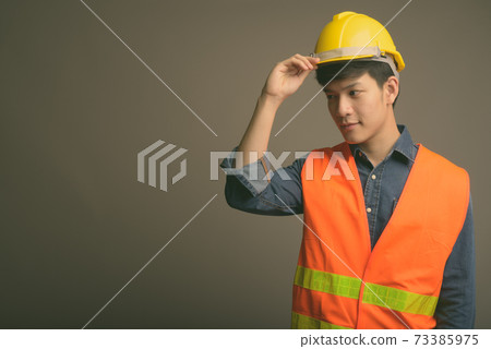 Young handsome Asian man construction worker... - Stock Photo [73385975 ...