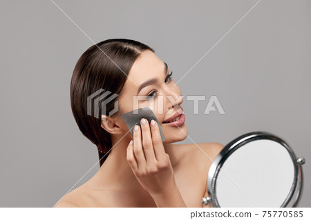 Skin care. Young woman removing oil from face... - Stock Photo ...