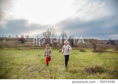 Children run into the field. Children play in... - Stock Photo ...