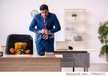 Young male employee and his toy bear boss in... - Stock Photo [77026725 ...
