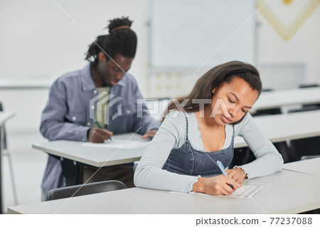 Students writing in classroom - Stock Photo [77237088] - PIXTA