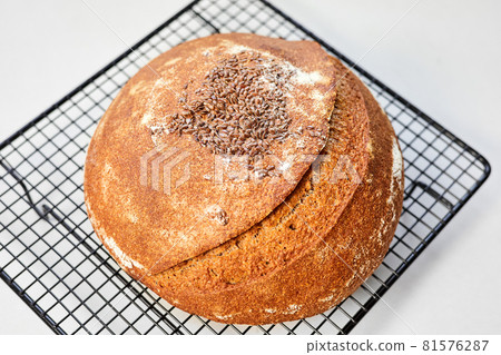 Homemade round rye bread on a metal wire rack.... - Stock Photo ...