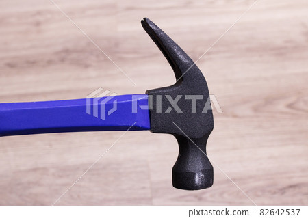 Blue hammer on a wooden background closeup - Stock Photo [82642537] - PIXTA