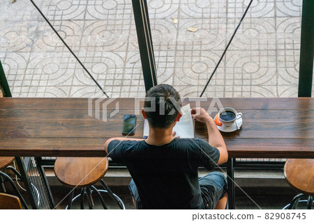 Asian man reading book in the morning - Stock Photo [82908745] - PIXTA
