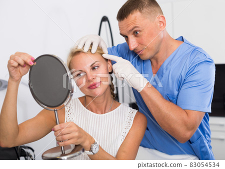 Man doctor is preparing female patient to... - Stock Photo [83054534 ...