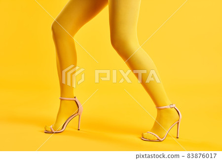 Long slim legs of young woman in yellow tights... - Stock Photo ...