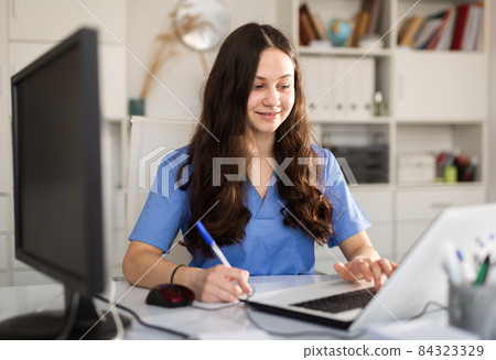 Young female doctor trainee making important... - Stock Photo [84323329 ...