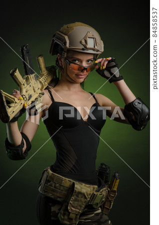 a soldier girl poses with an automatic rifle - Stock Photo [84858537 ...