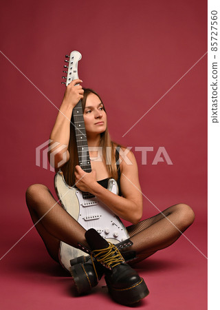 Beautiful young woman posing with guitar in... - Stock Photo [85727560 ...