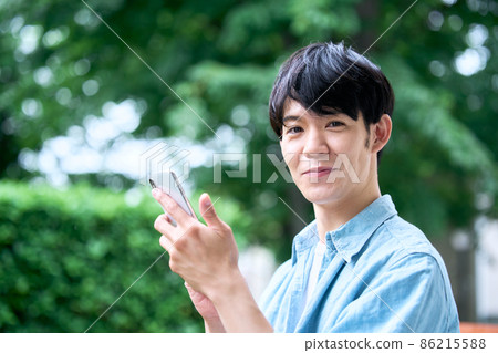 A man operating a smartphone - Stock Photo [86215588] - PIXTA