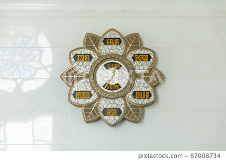 [UAE] Clock showing the time of worship on the... - Stock Photo ...