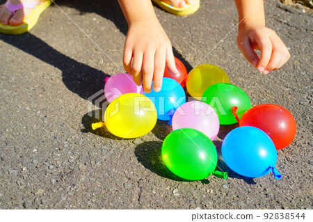 Playing with colorful water balloons - Stock Photo [92838544] - PIXTA