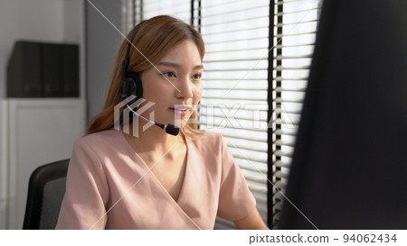 Competent female operator working on computer... - Stock Photo ...