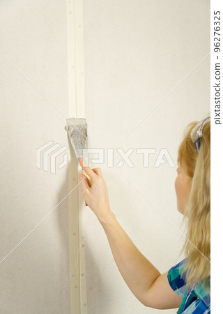 Woman putty plaster. Builder female indoor... - Stock Photo [96276325 ...