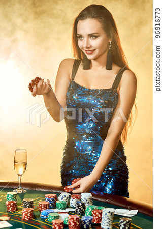 Young beautiful woman poses near poker table in... - Stock Photo ...