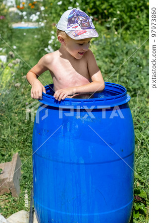 A preschooler boy from a poor family is bathing... - Stock Photo ...