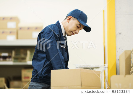 A man in work clothes sorting in a distribution... - Stock Photo ...