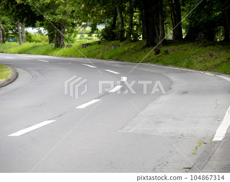 Curved one-lane road and white dashed center line. - Stock Photo ...