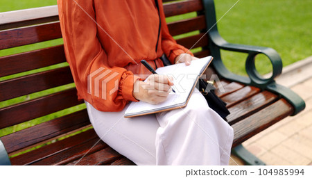 Park, bench and a woman writing in a notebook,... - Stock Photo ...