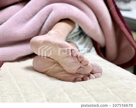 The soles of elderly women's feet emerging from... - Stock Photo ...