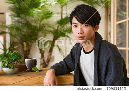 A young Asian man looking at me with a serious... - Stock Illustration ...