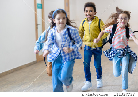 A Group Of Elementary School Kids Rushing Out Of School In A School