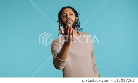 Middle Eastern frisky playful man blowing...-照片素材（圖片） [115027268] - PIXTA圖庫