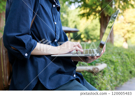 Woman using laptop in park, outdoor work image - Stock Photo [120005483 ...