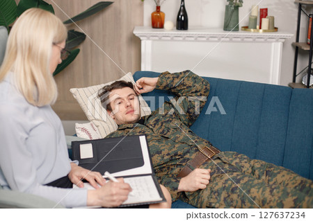 Soldier laying on couch during therapy session.... - Stock Photo ...
